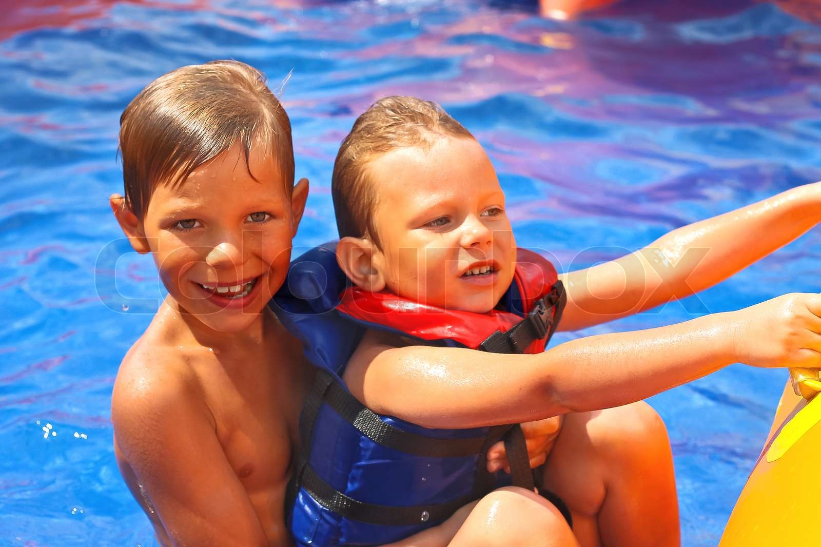 Two brothers in swimming pool at the water park | Stock image | Colourbox