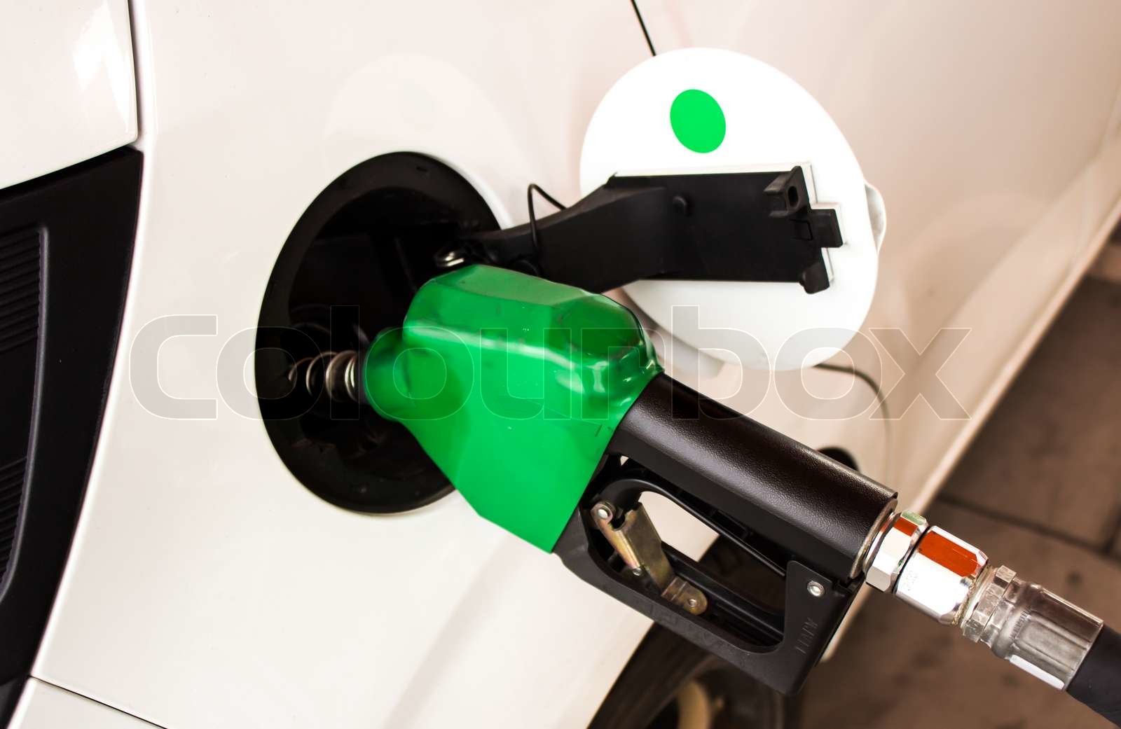 Blue Fuel nozzle add fuel in car in gas staion | Stock image | Colourbox