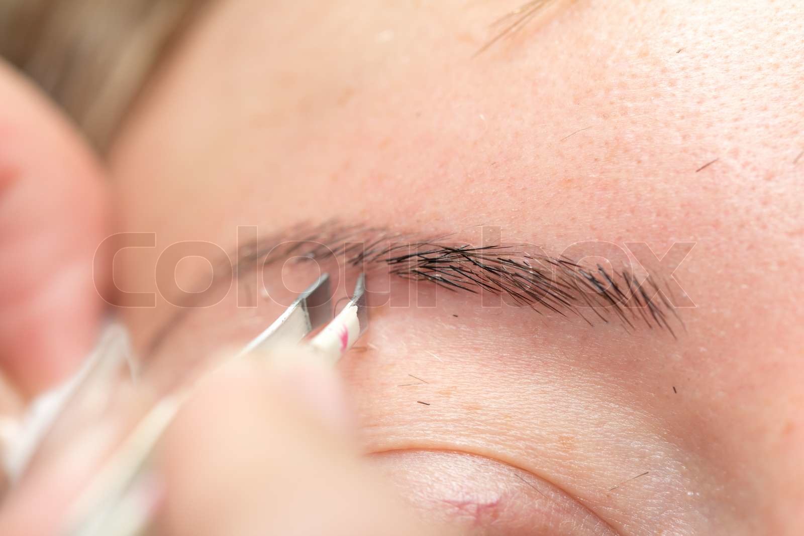 plucking eyebrows in cosmetology | Stock image | Colourbox