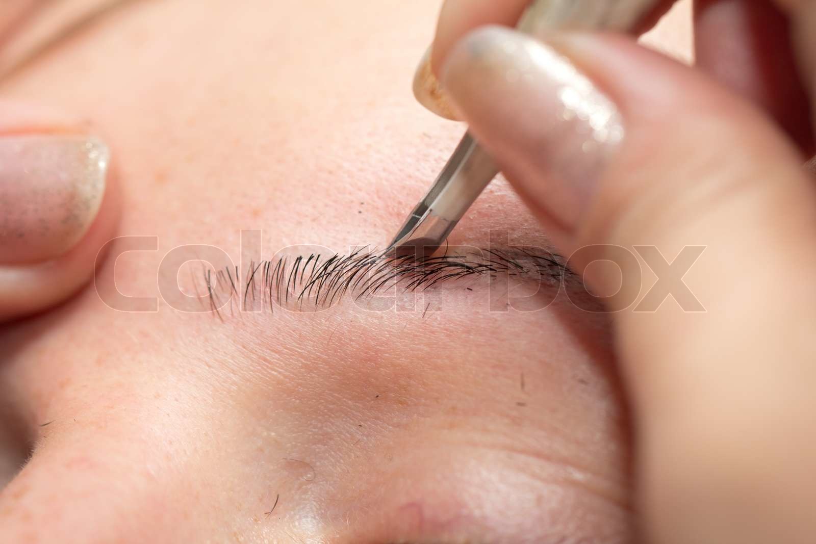plucking eyebrows in cosmetology | Stock image | Colourbox