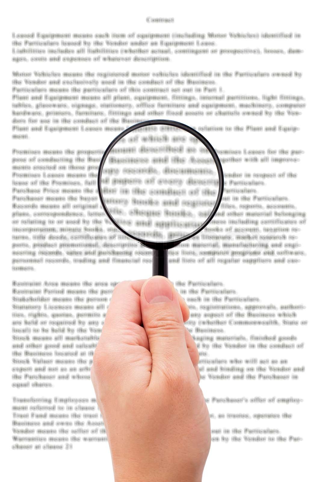 Hand holding magnifying glass reading document | Stock image | Colourbox