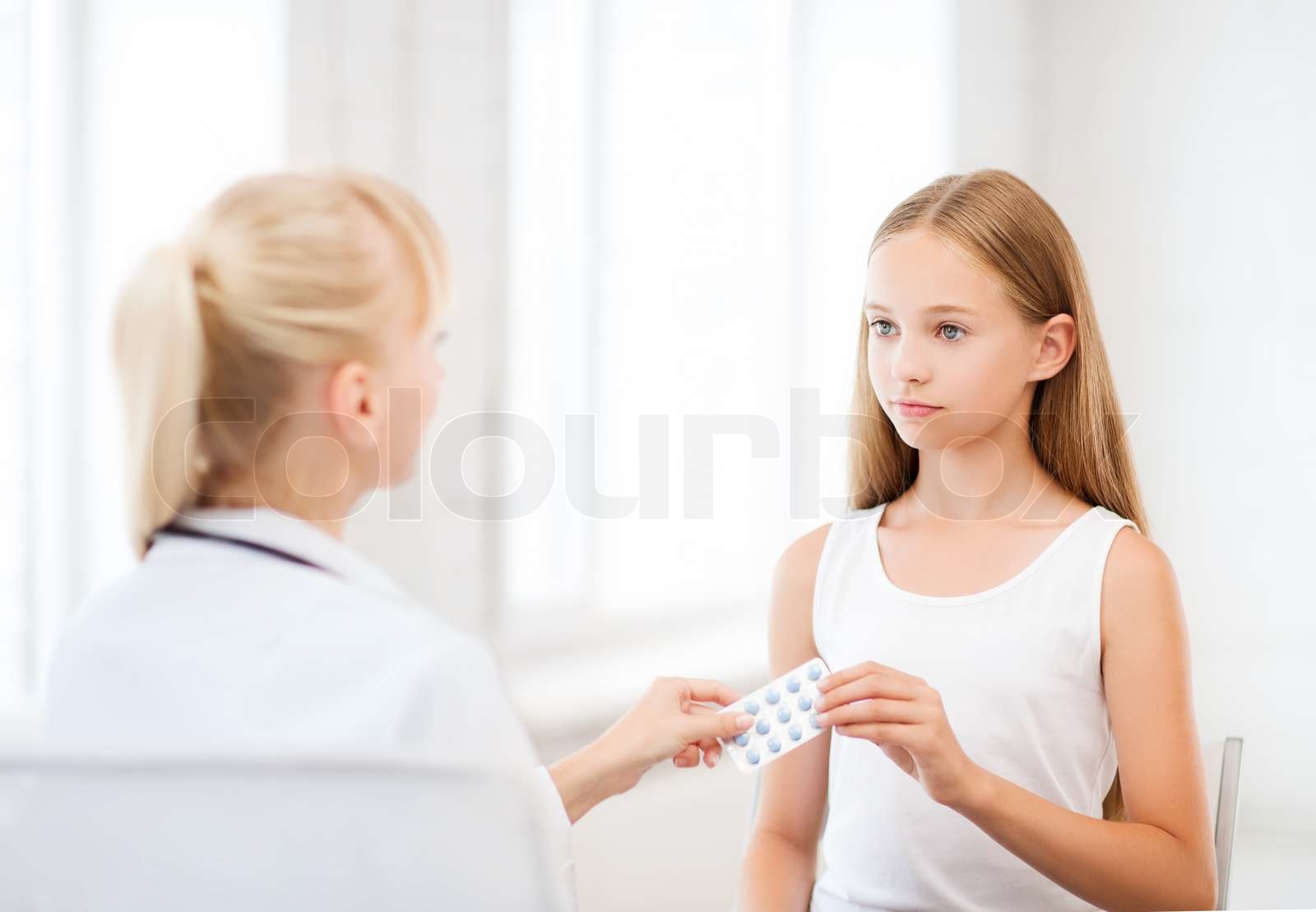 doctor giving tablets to child in hospital | Stock image | Colourbox
