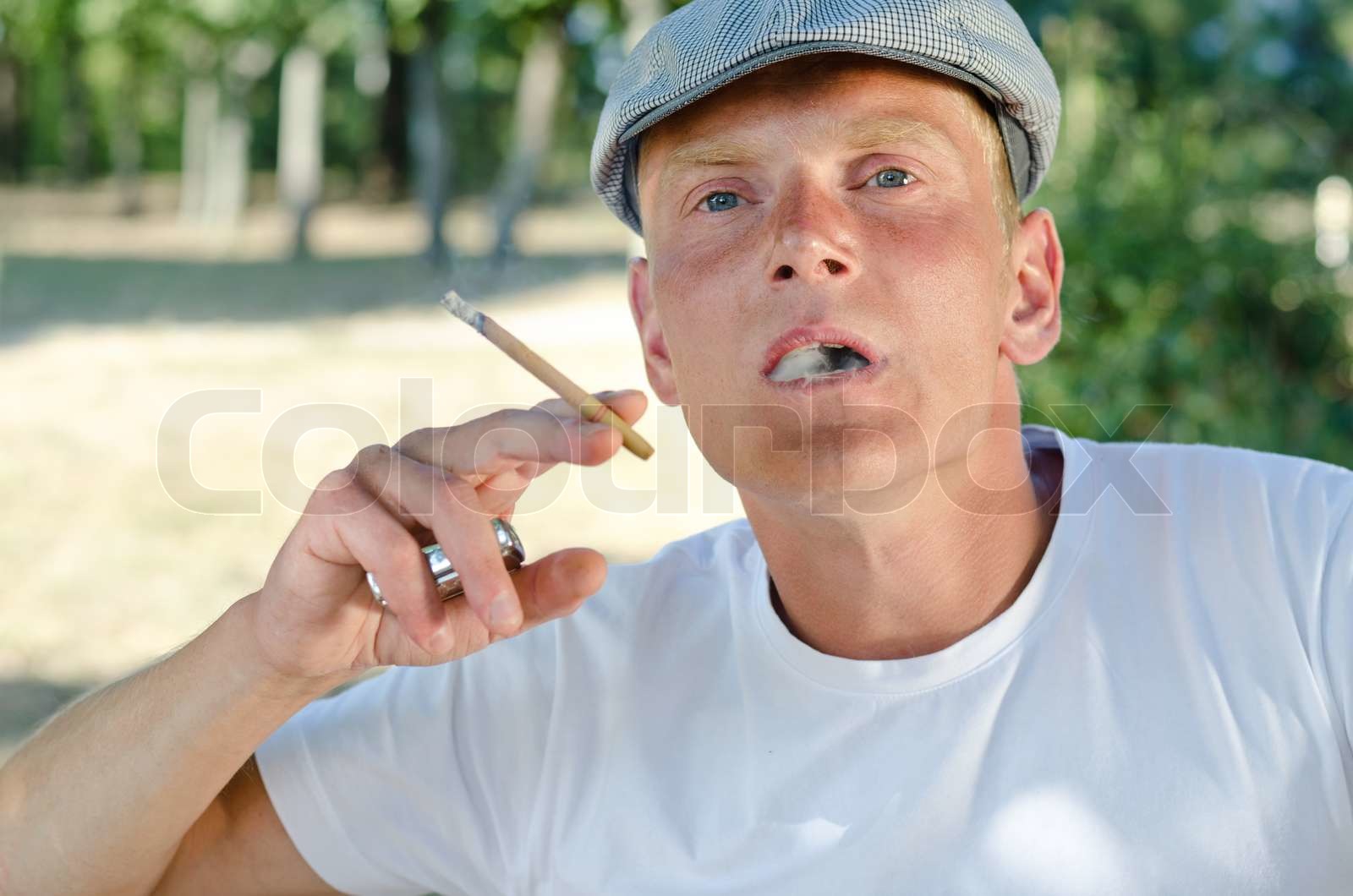 Young man enjoying a cigarette | Stock image | Colourbox