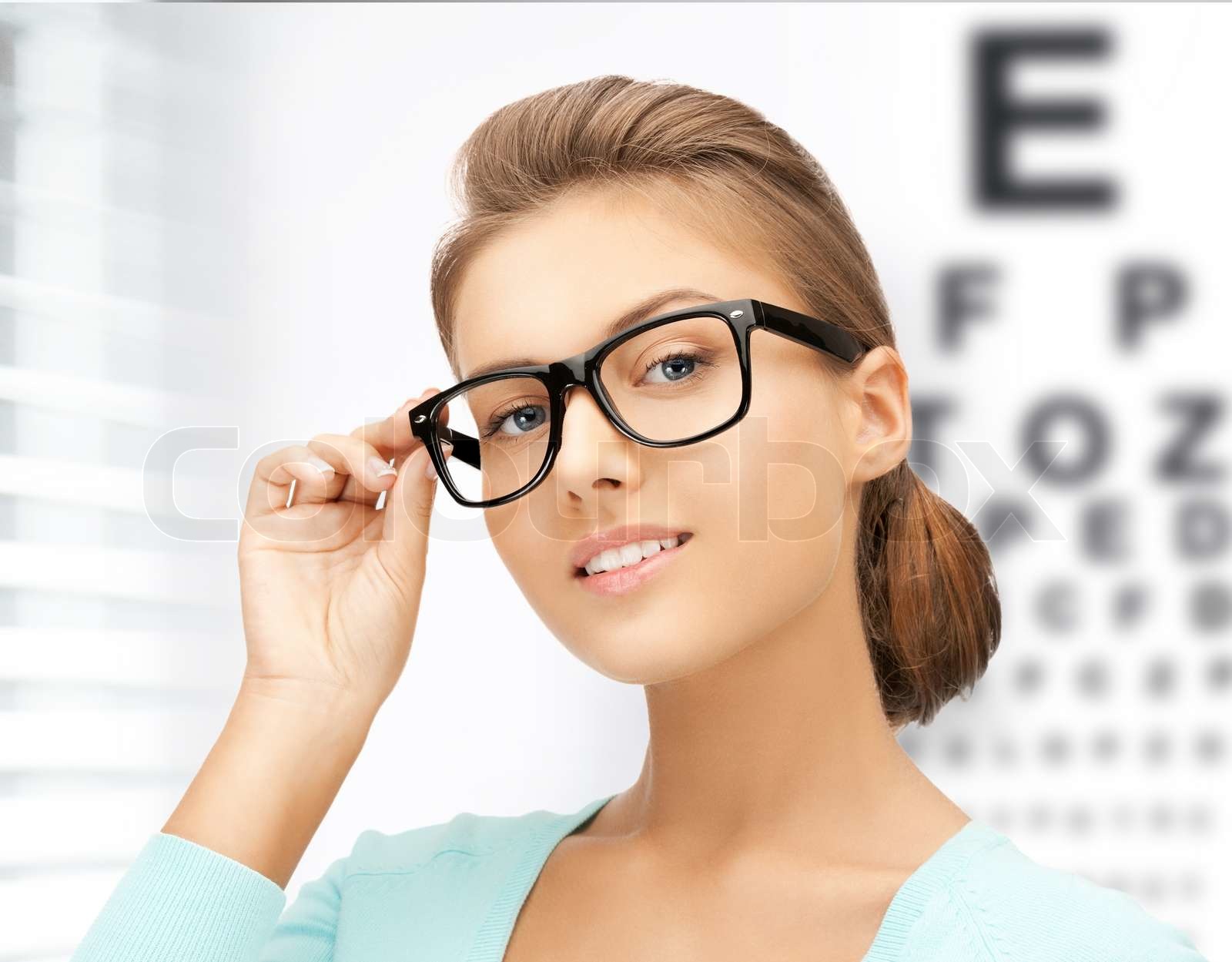 woman in eyeglasses with eye chart | Stock image | Colourbox