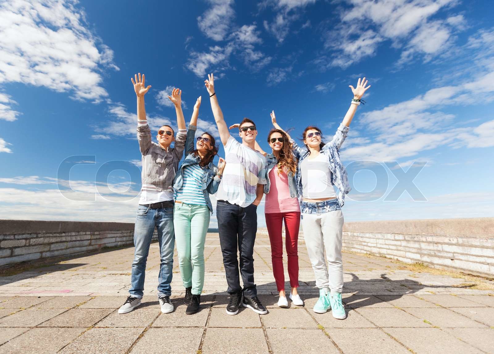 group of teenagers holding hands up | Stock image | Colourbox