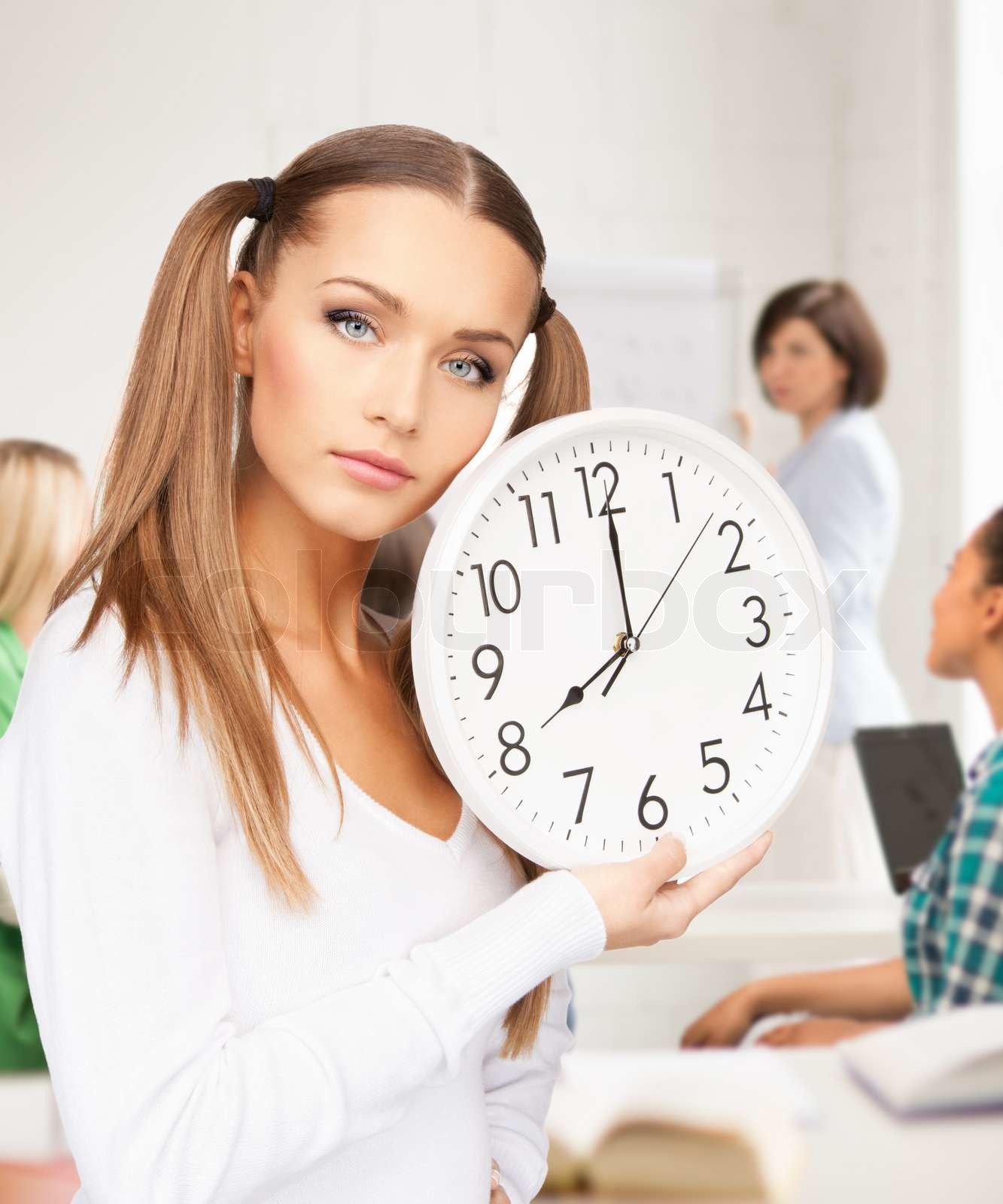 student showing clock | Stock image | Colourbox