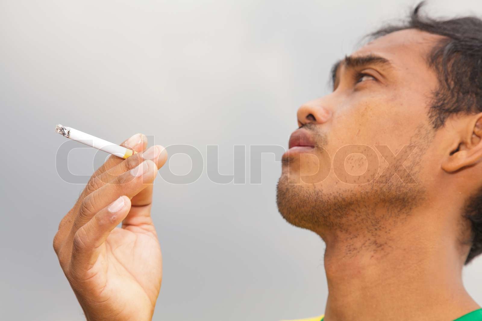 Man smoking a cigarette | Stock image | Colourbox