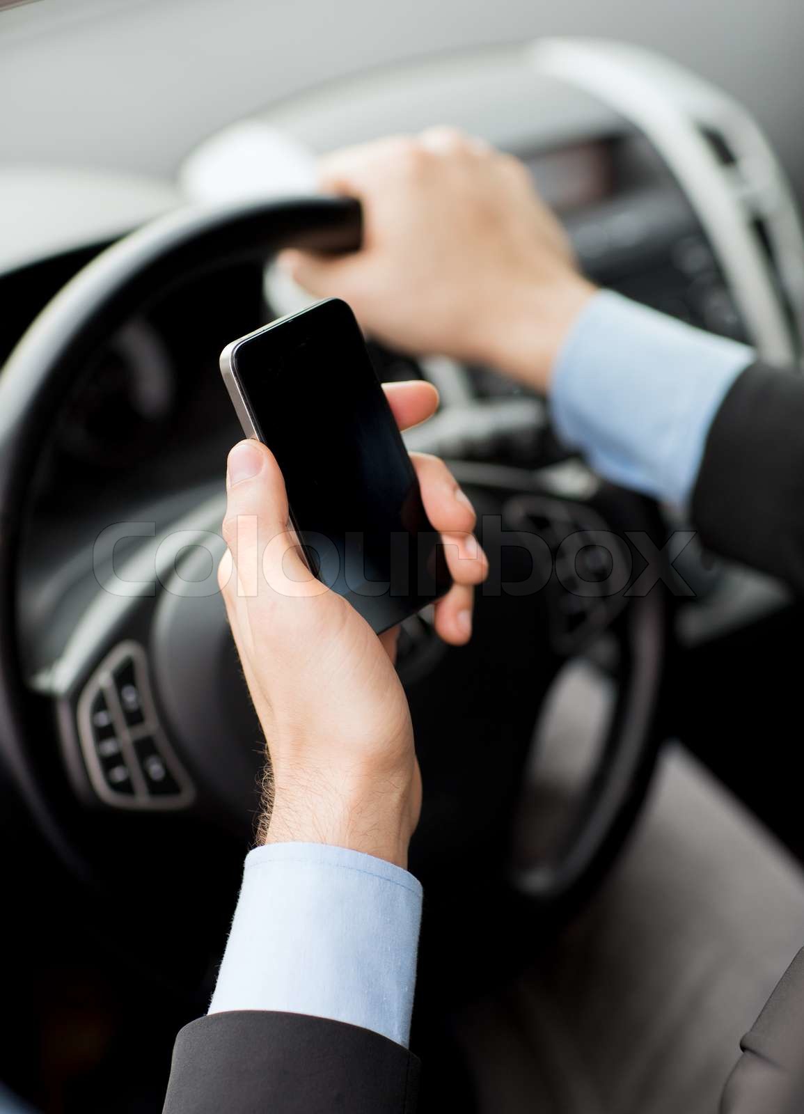 man using phone while driving the car | Stock image | Colourbox