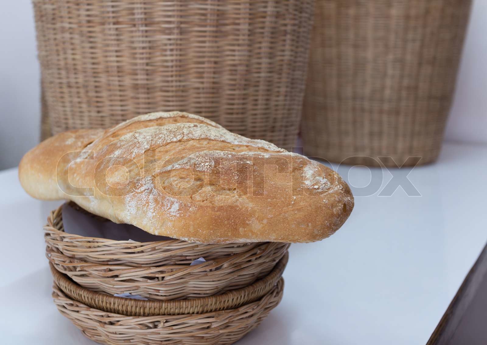 Bread baton in bamboo basket | Stock image | Colourbox