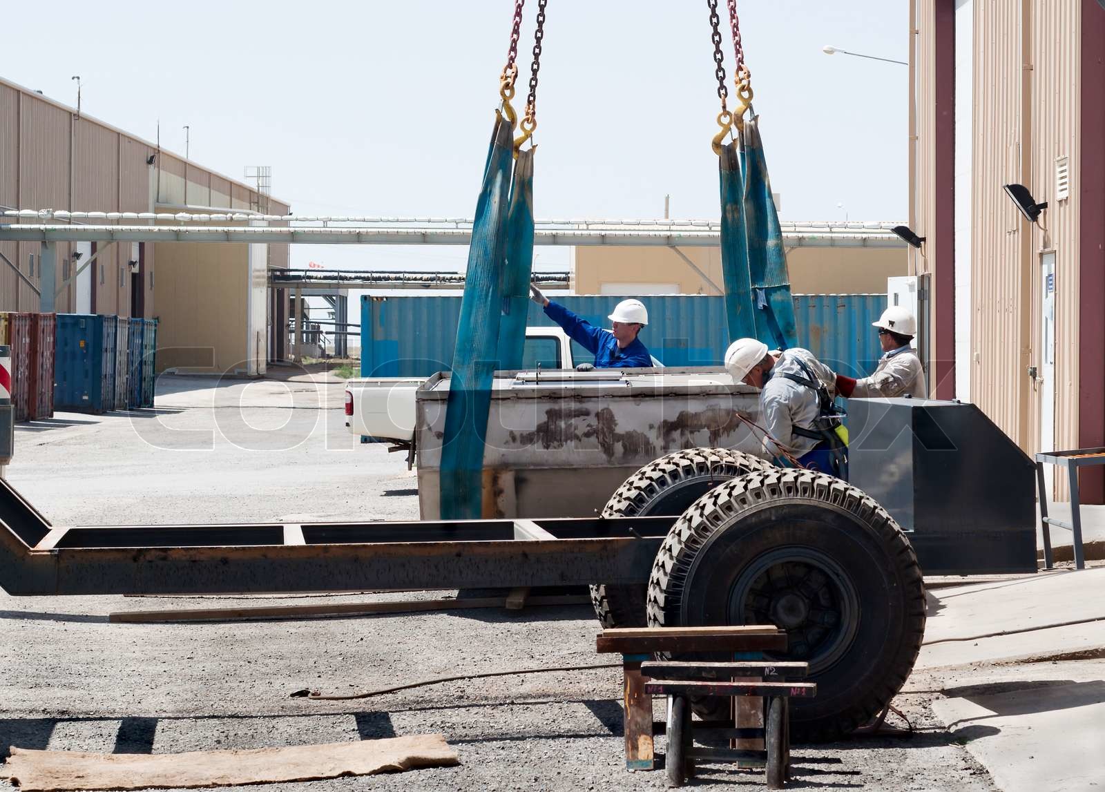 Unloading of steel capacity on industrial area | Stock image | Colourbox