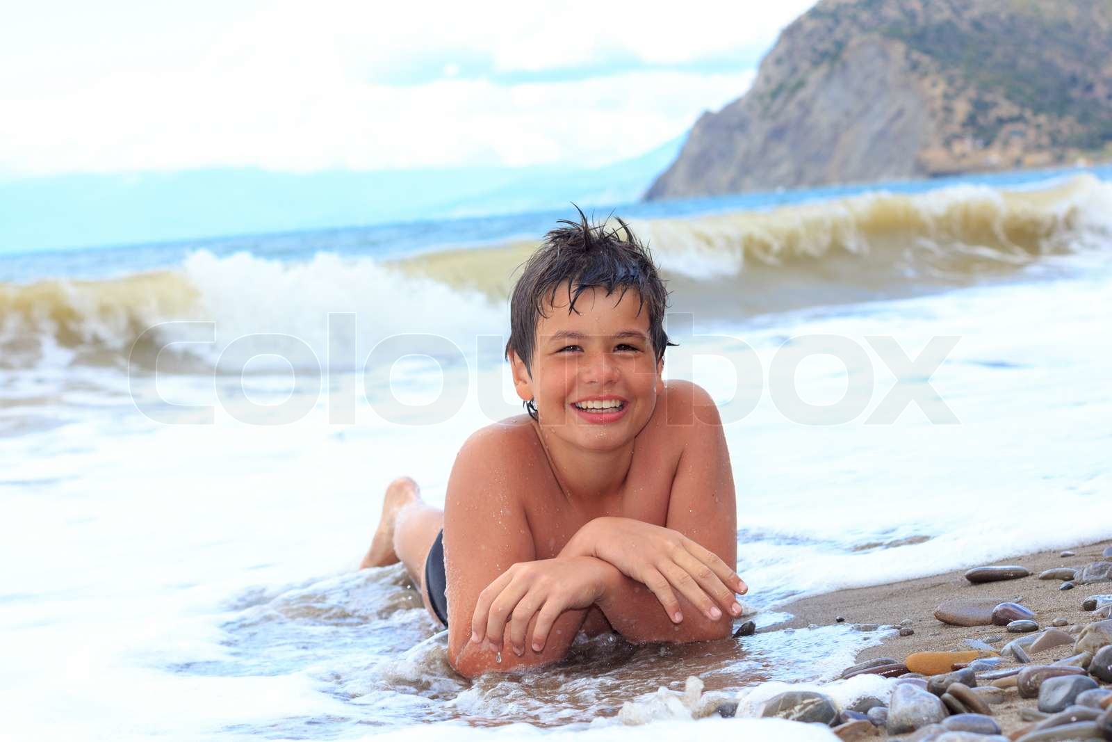Happy smiling boy on the sea beach | Stock image | Colourbox