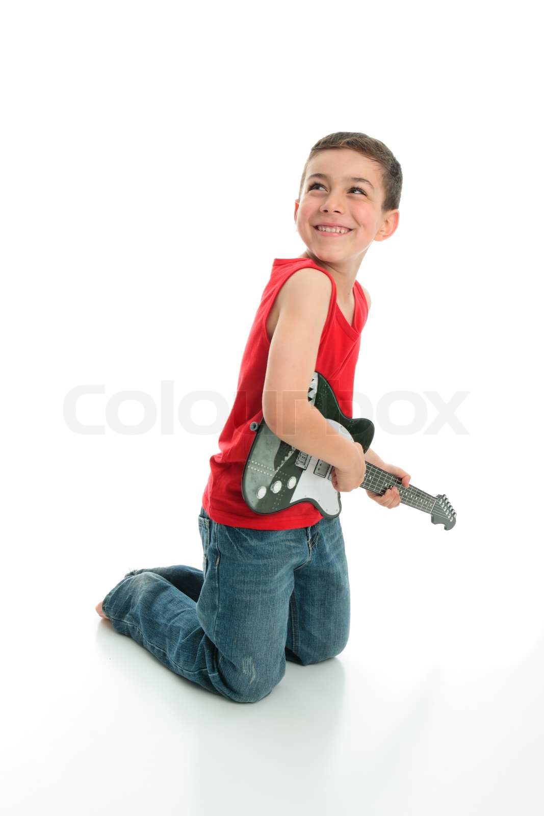 Little boy playing guitar | Stock image | Colourbox
