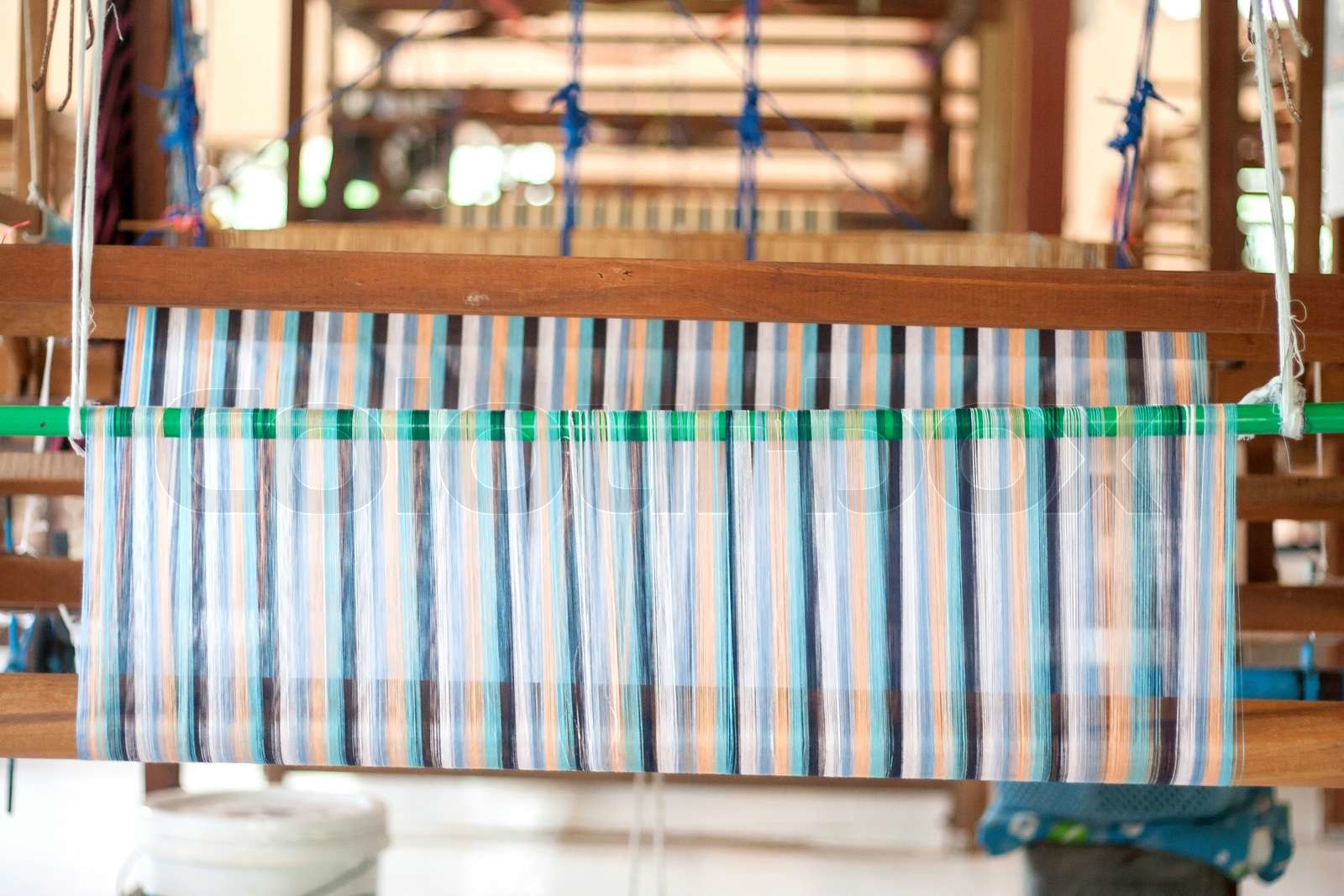 Silk weaving on a hand loom in thailand | Stock image | Colourbox