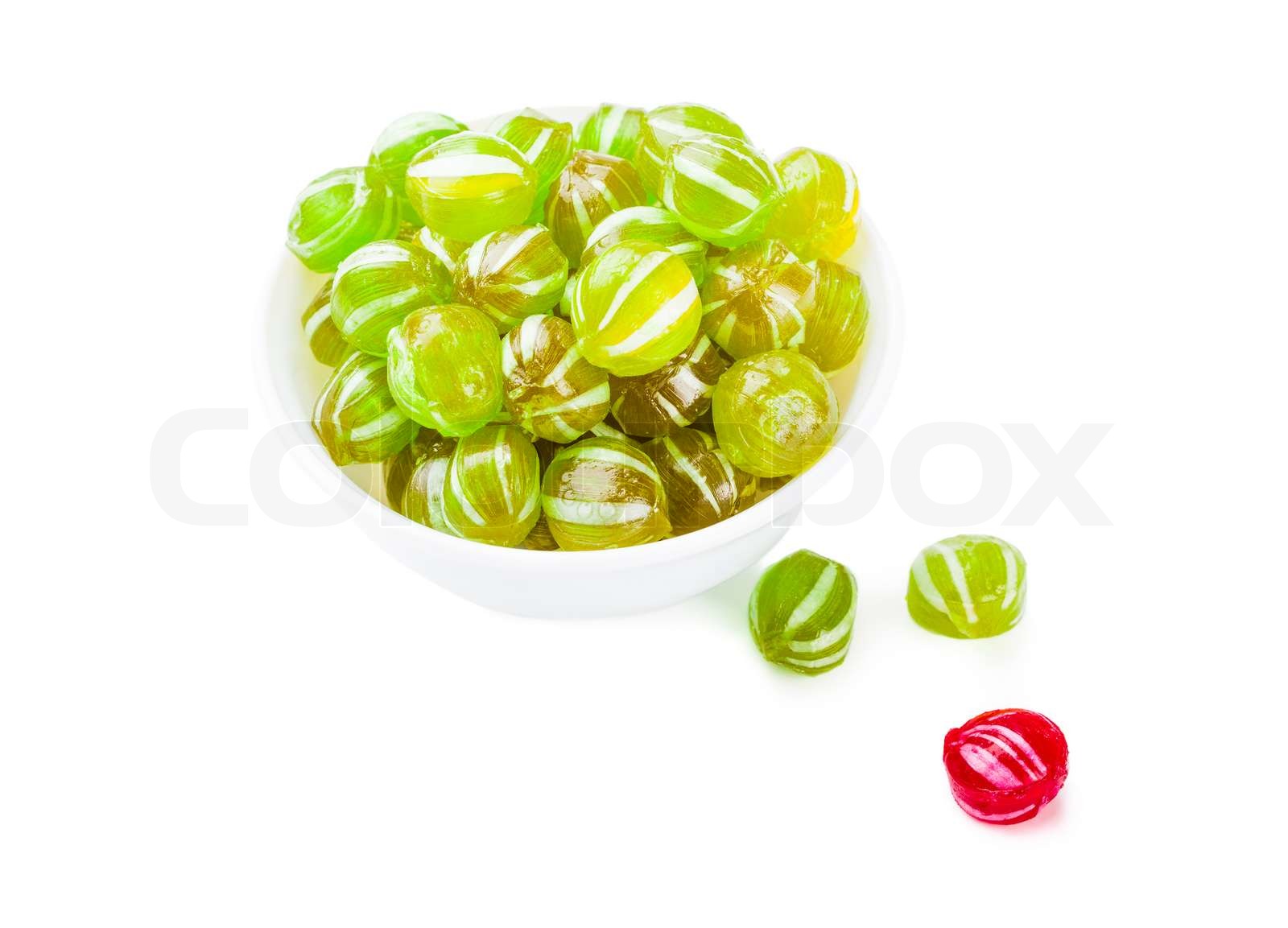 Ball shaped candy in bowl isolated on white | Stock image | Colourbox