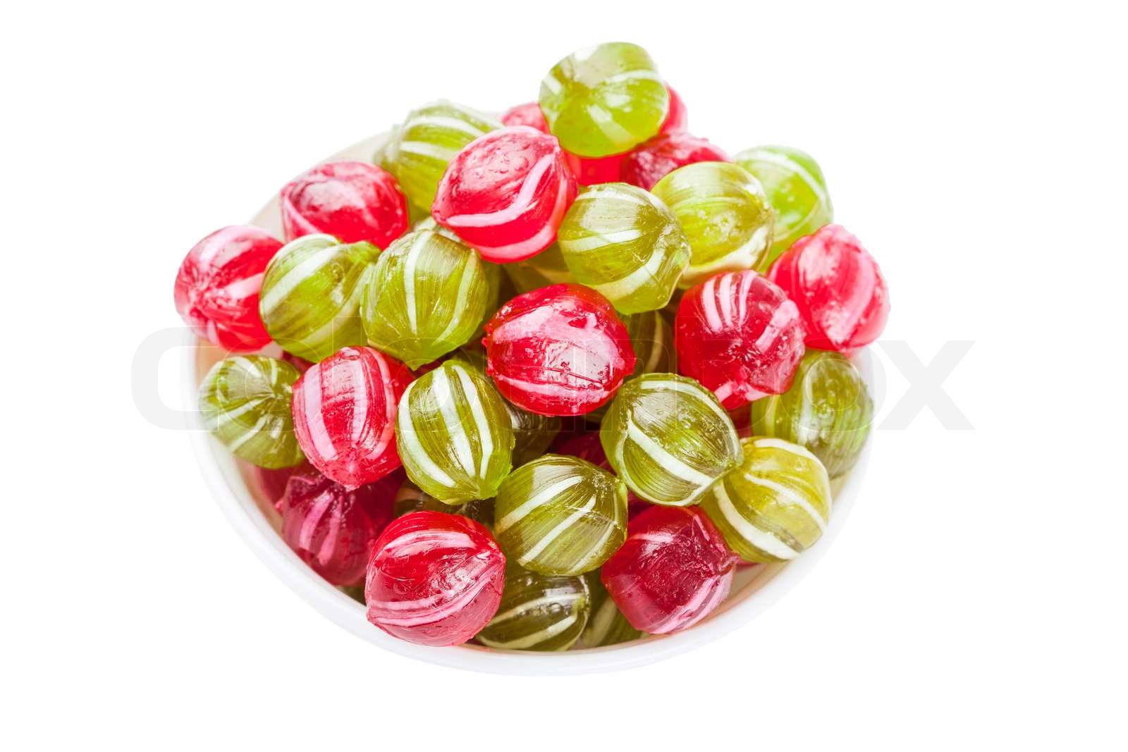 Ball shaped candy in bowl isolated on white | Stock image | Colourbox