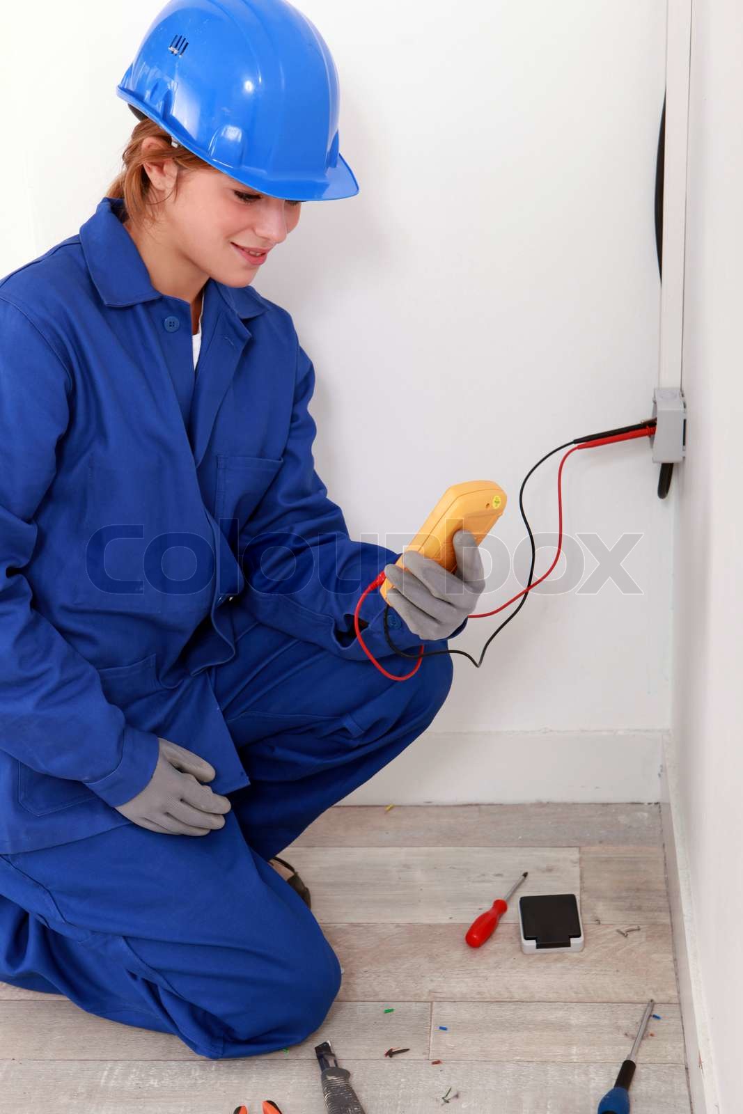 Female electrician taking electrical reading | Stock image | Colourbox