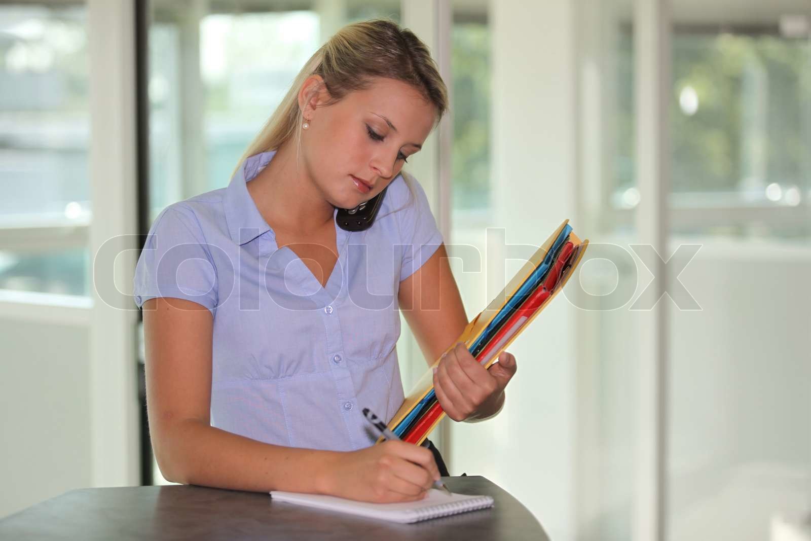 Busy receptionist multitasking | Stock image | Colourbox