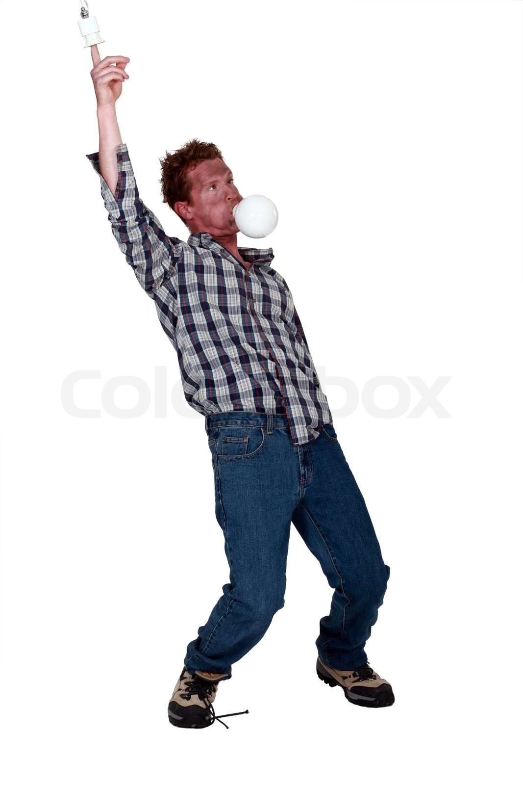 Man with his finger in a light socket | Stock image | Colourbox
