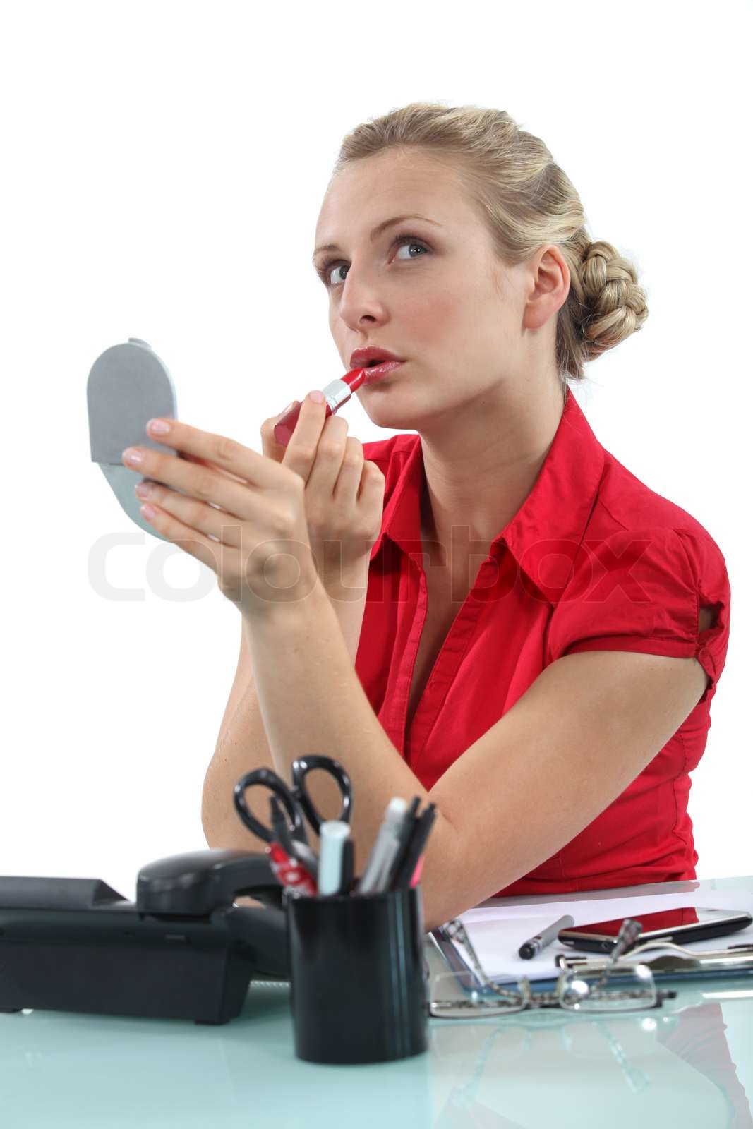 Blond Secretary Applying Lip Stick At Her Desk Stock Image Colourbox