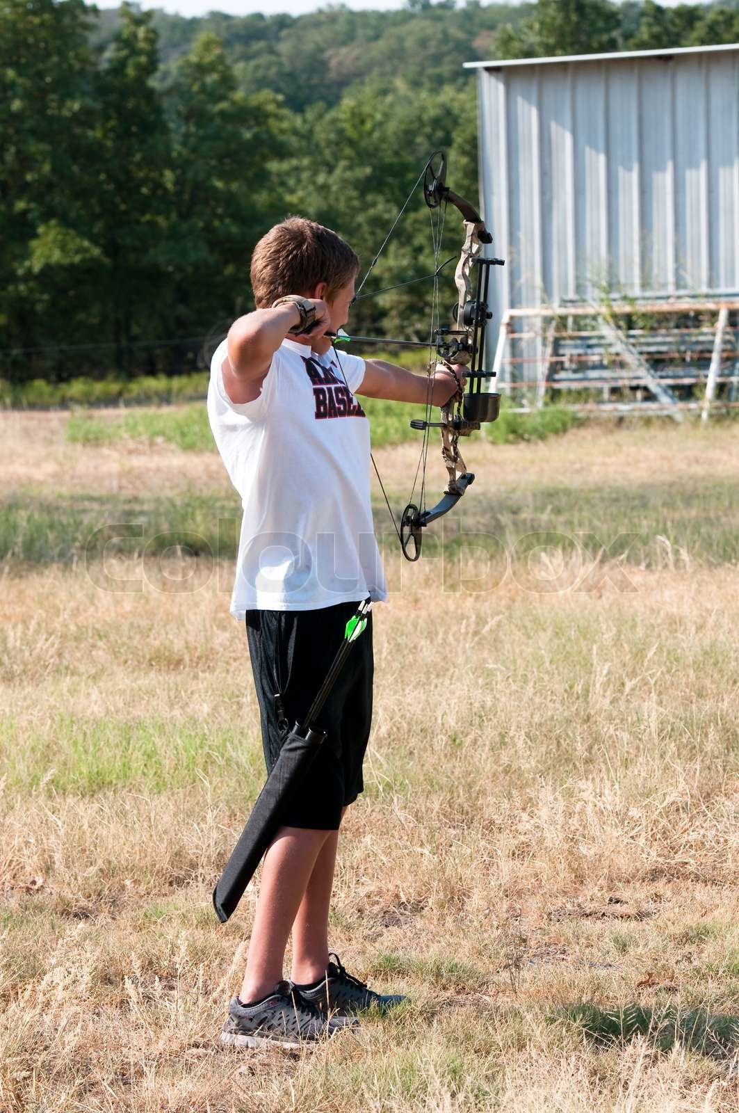 Teen boy bow hunting | Stock image | Colourbox