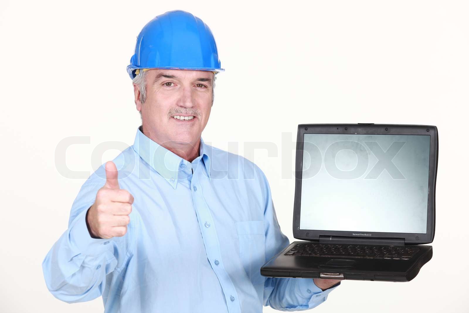 Thumbs up from an engineer with a laptop | Stock image | Colourbox