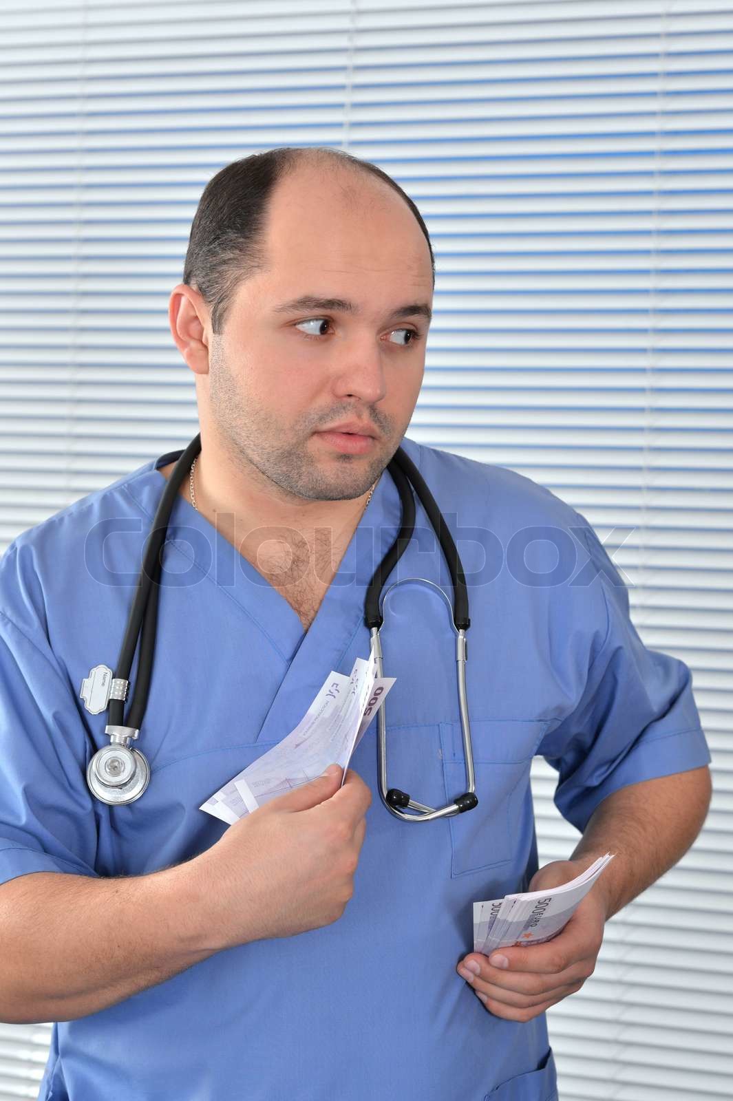 portrait of a doctor in blue uniform | Stock image | Colourbox