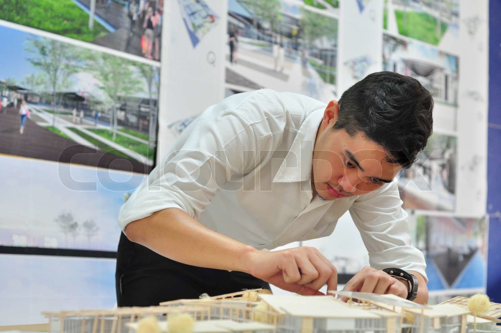 An Architect student is modeling on site. | Stock image | Colourbox