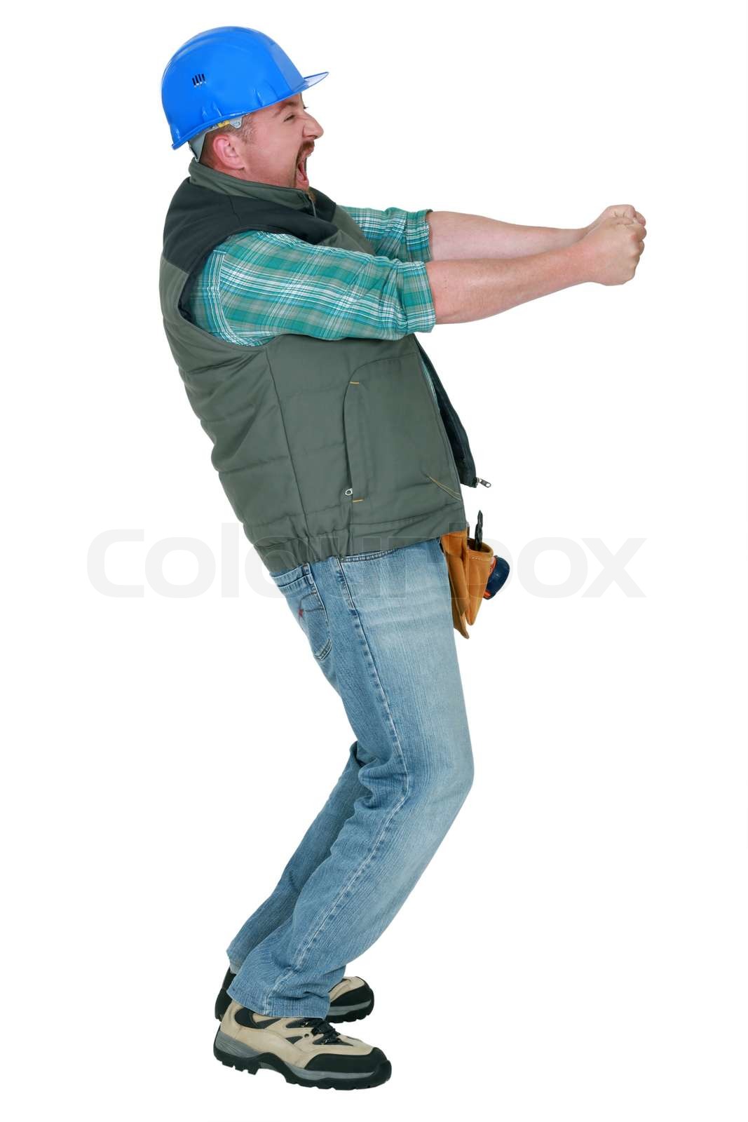 Construction worker pulling something | Stock image | Colourbox