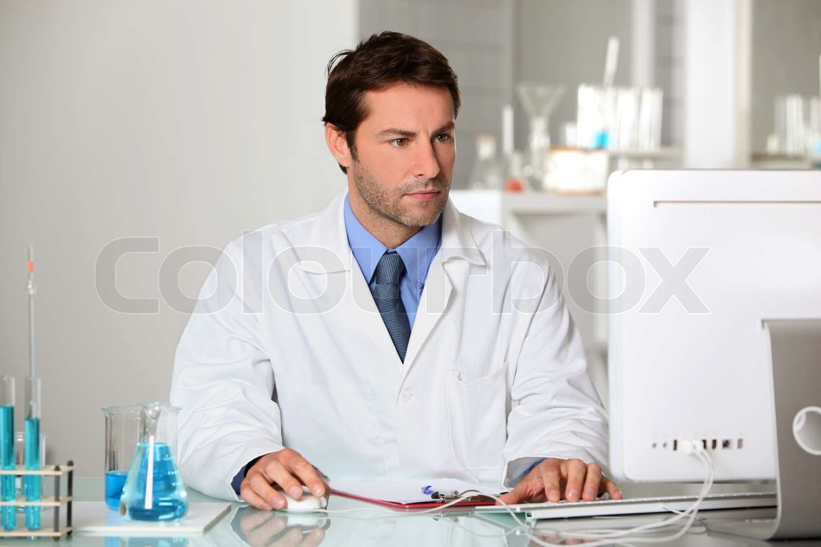 Lab technician studying test results on a computer | Stock image ...