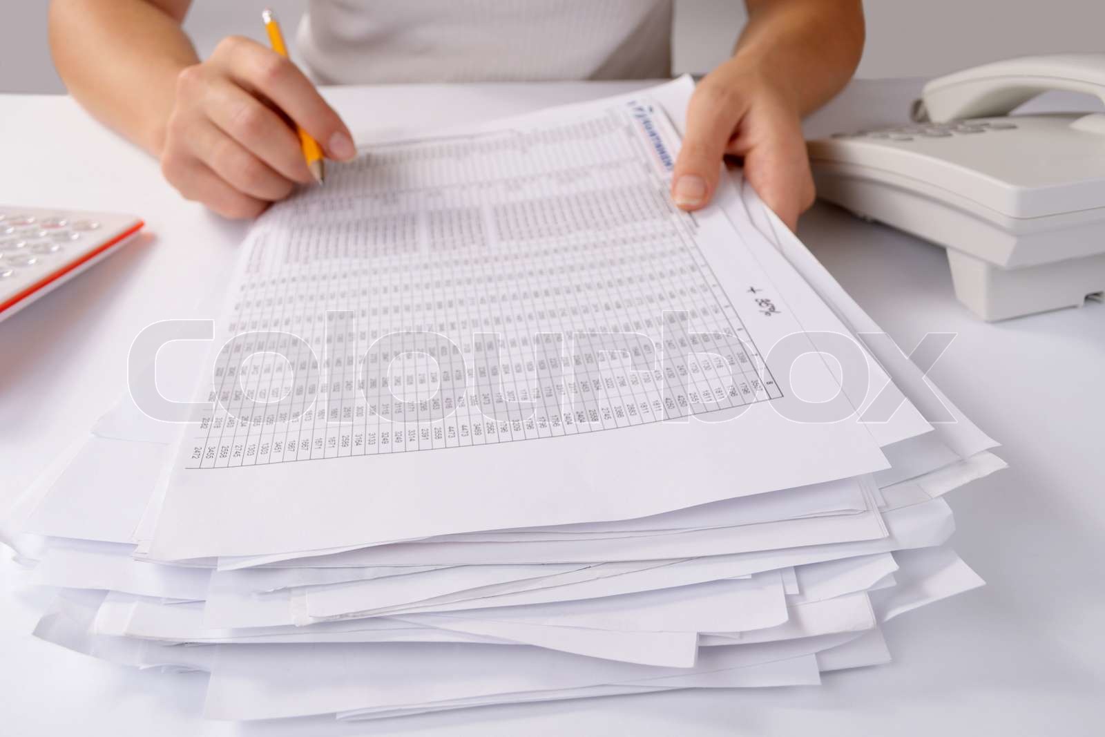 Hands holding a batch of loose paperwork | Stock image | Colourbox