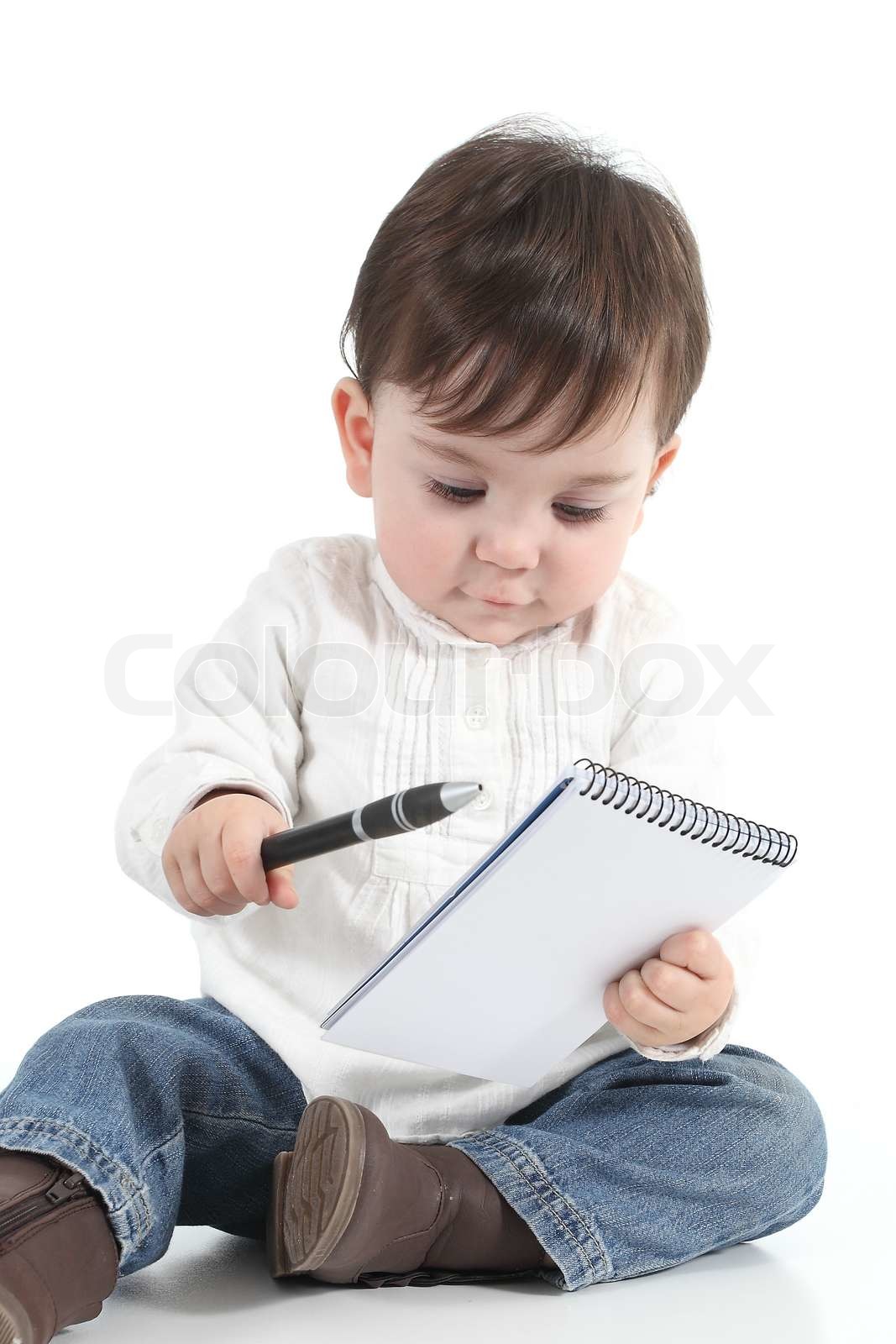 Baby with a notebook and a pen | Stock image | Colourbox