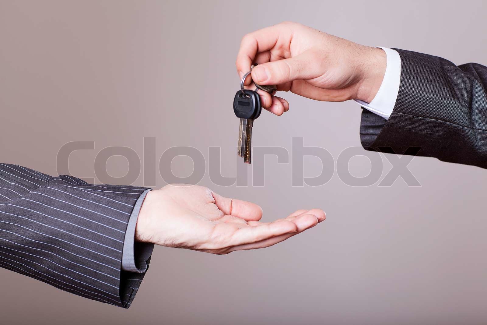 man giving keys | Stock image | Colourbox
