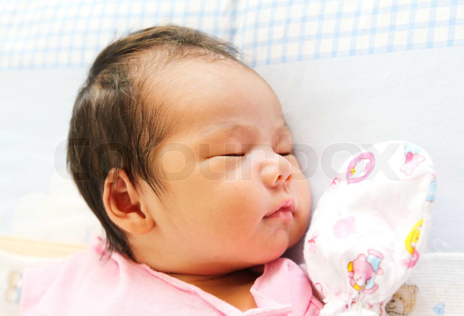 Newborn Asian baby girl sleeping | Stock image | Colourbox