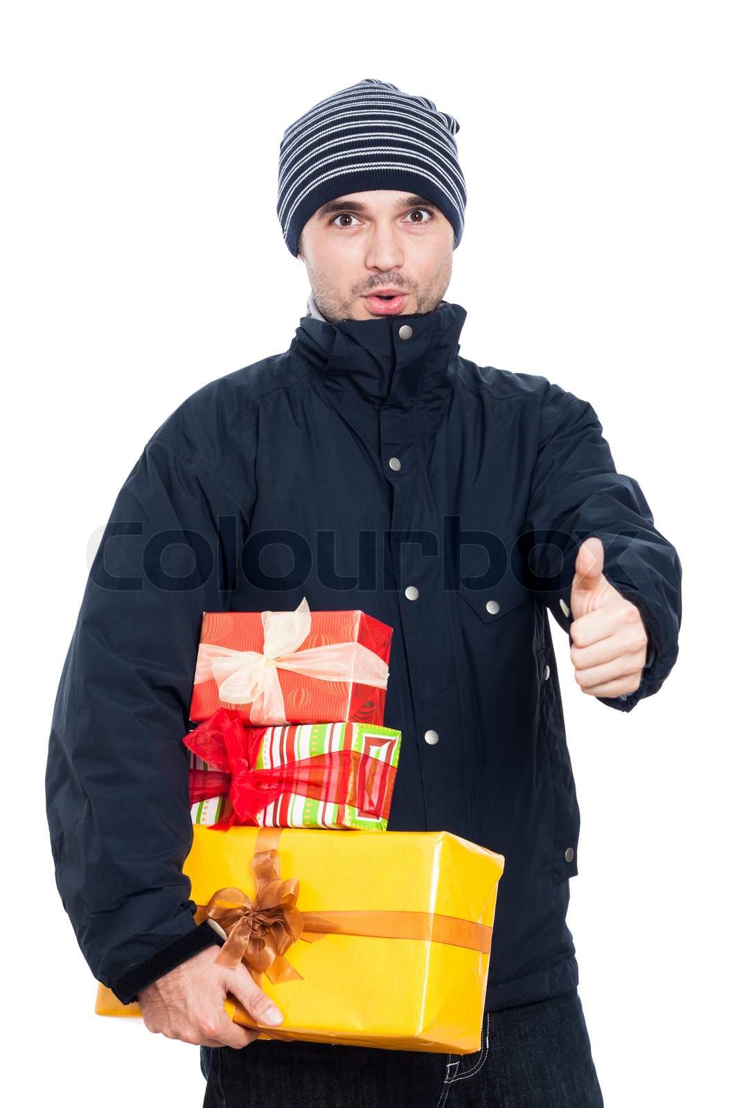 Surprised man with presents thumbs up | Stock image | Colourbox