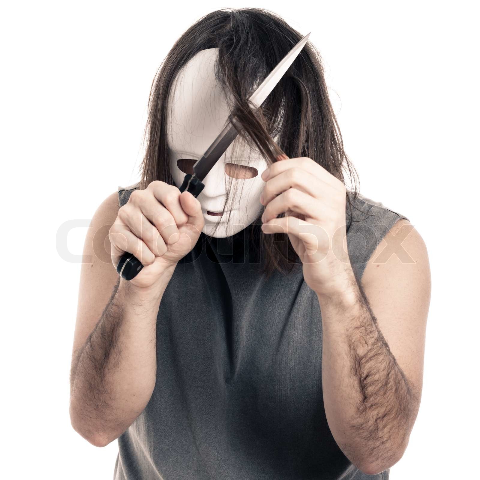 Scary man cutting his hair | Stock image | Colourbox