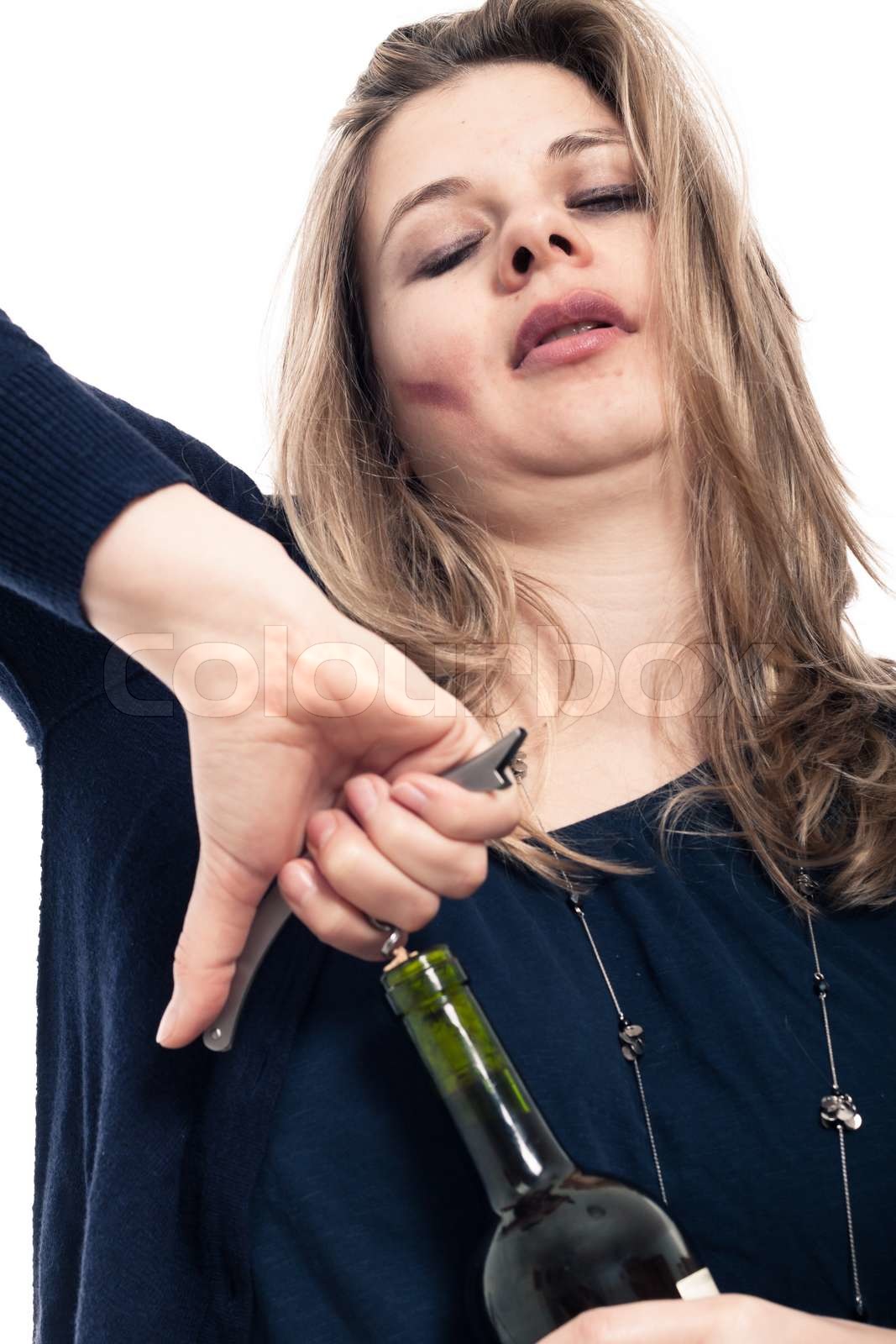 Drunk woman opening bottle of alcohol | Stock image | Colourbox