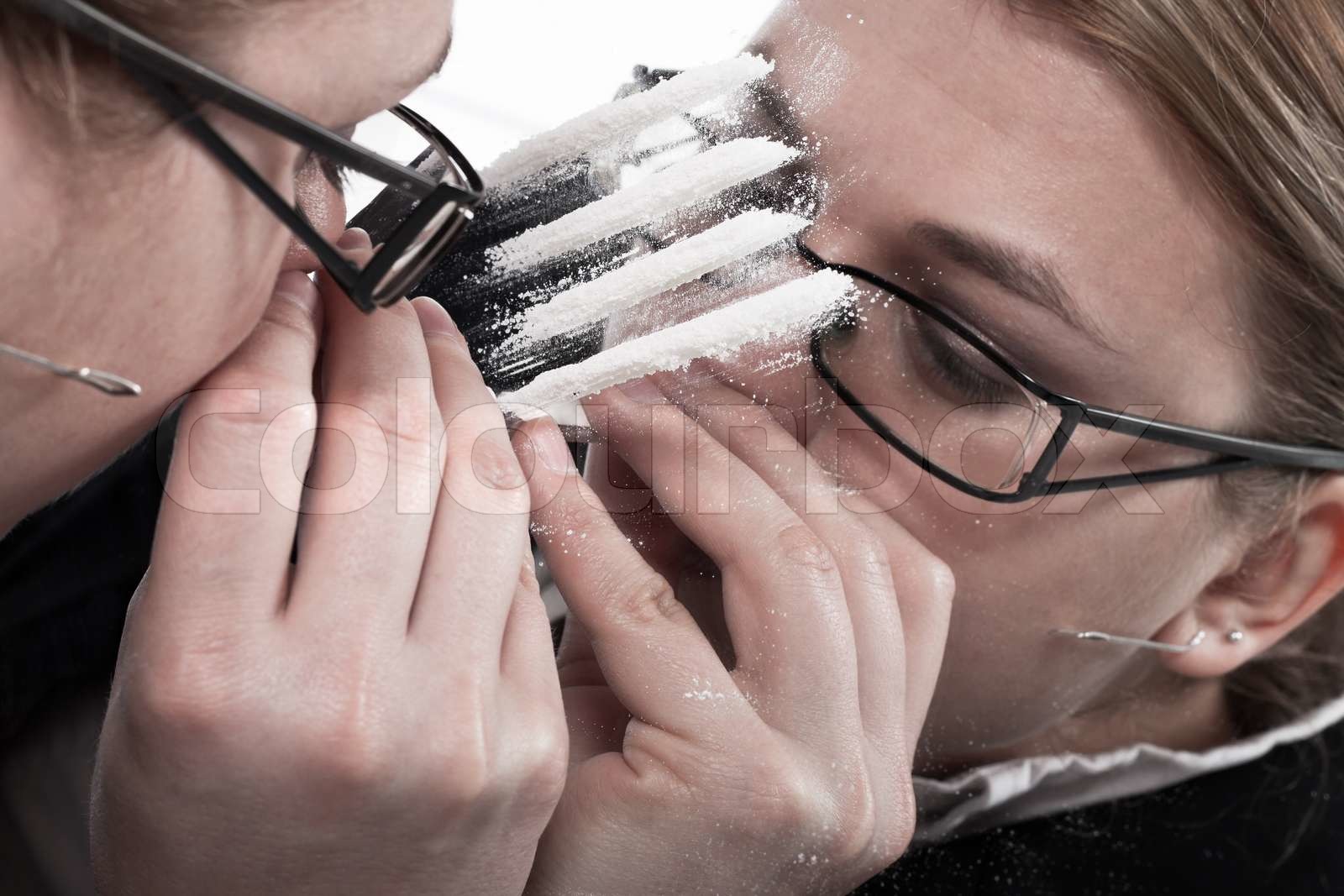 Drug addicted businesswoman snorting cocaine | Stock image | Colourbox