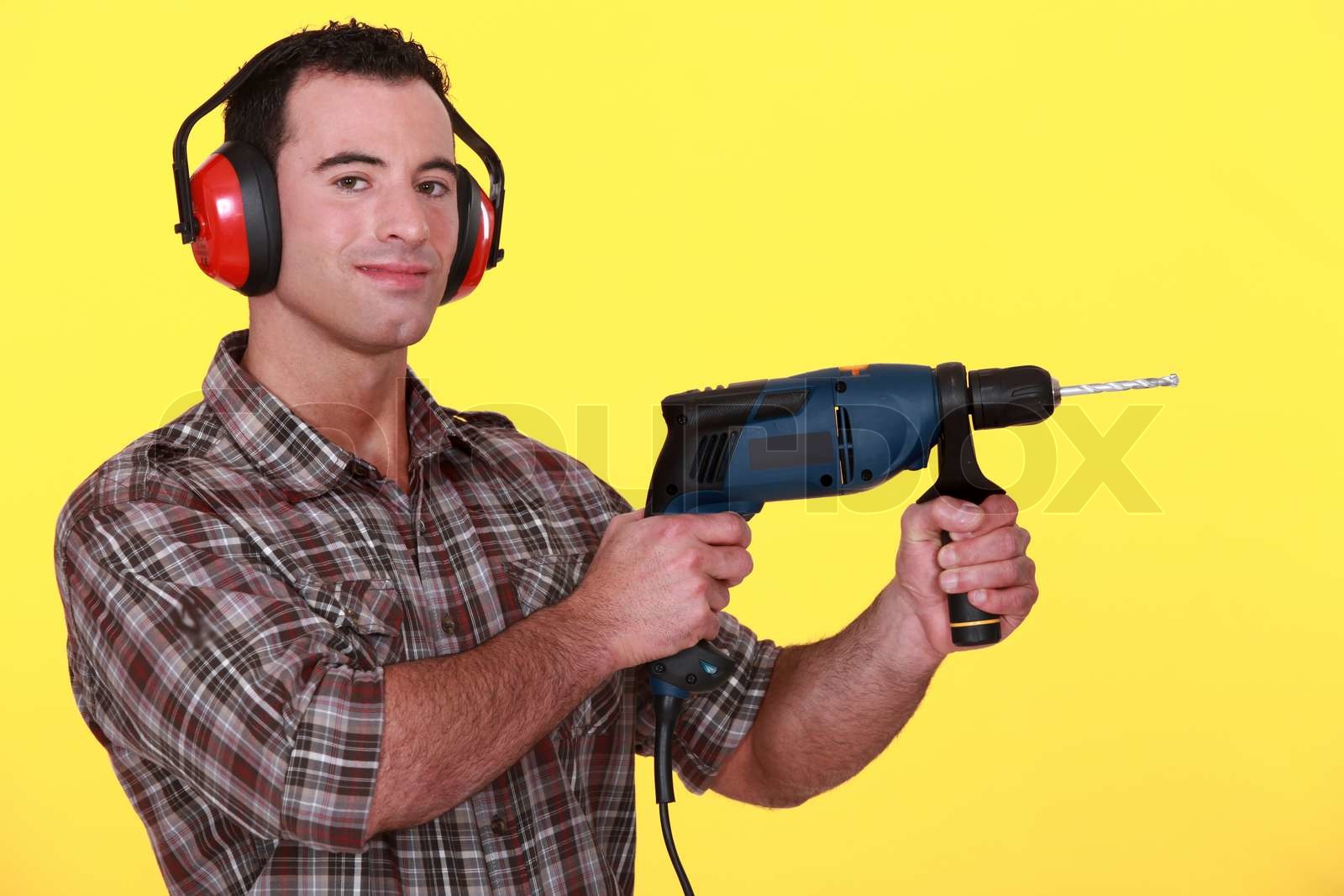 Man holding an electric screwdriver | Stock image | Colourbox