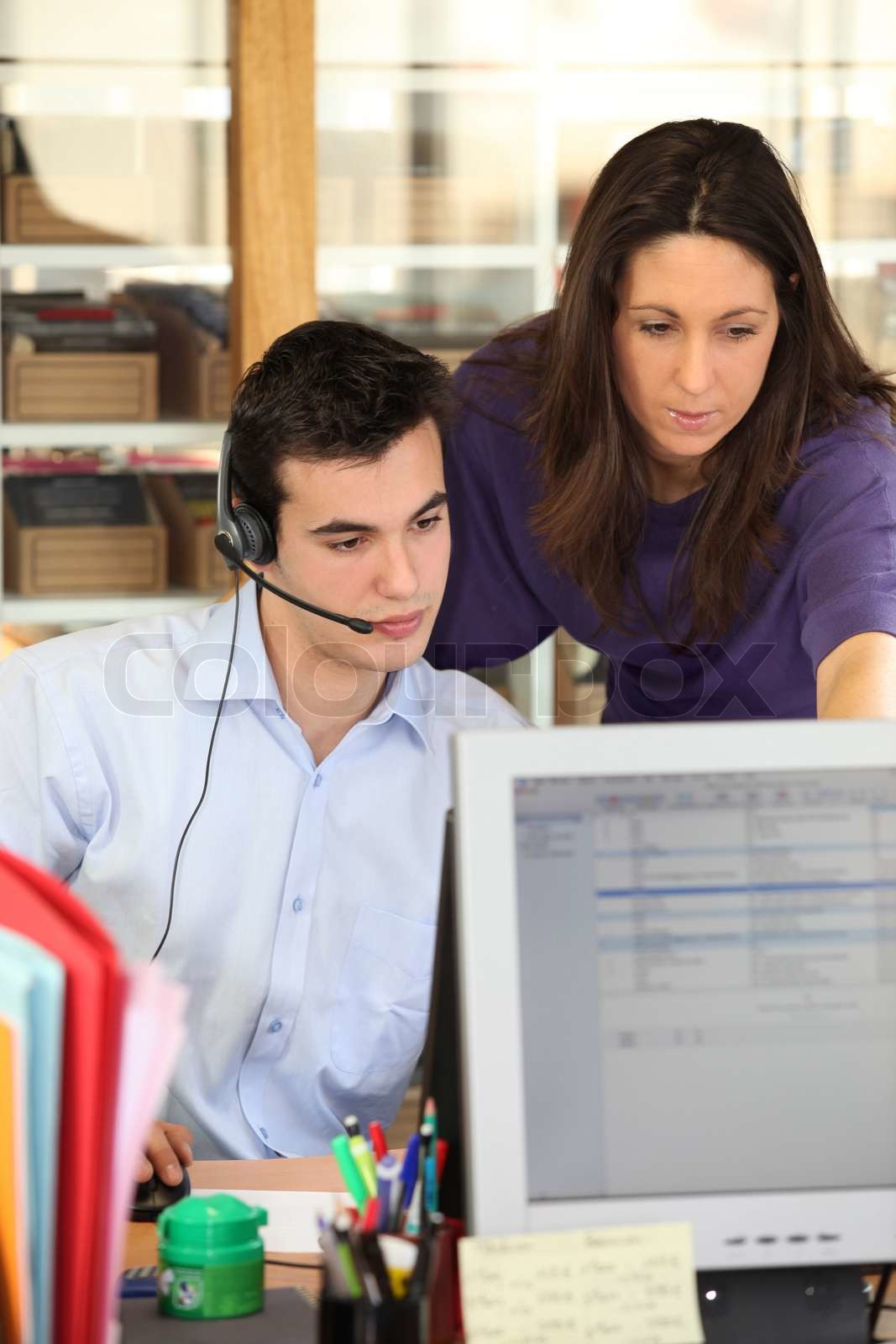 Teleoperator working in a call center | Stock image | Colourbox