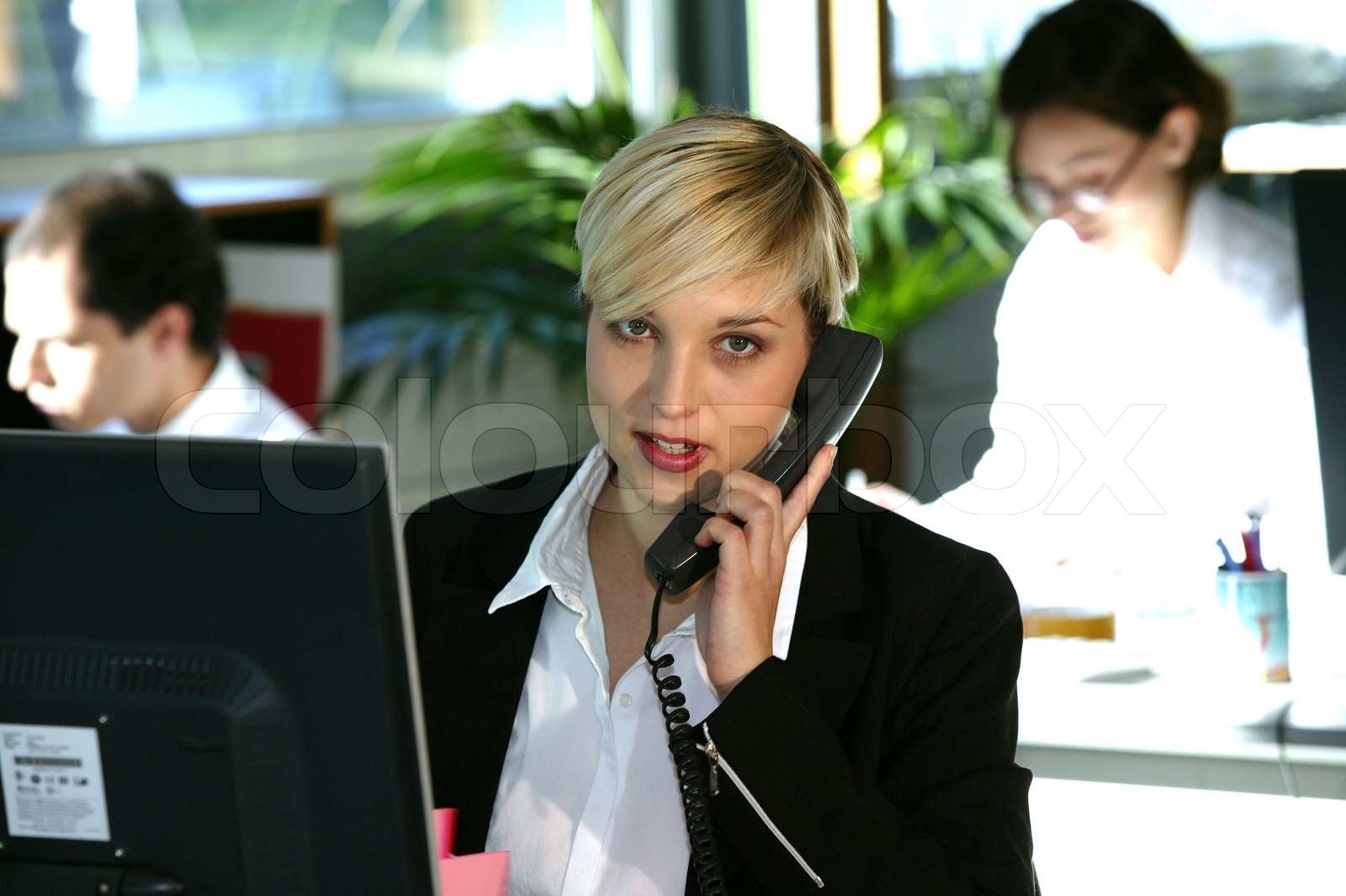Busy blond office worker | Stock image | Colourbox