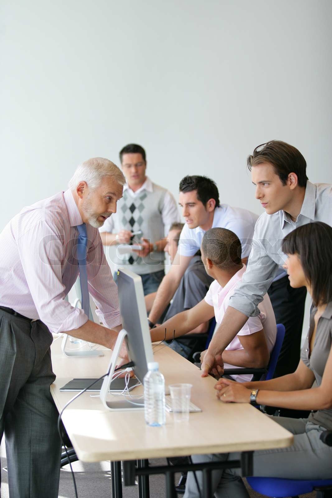 Active business team working round computers | Stock image | Colourbox