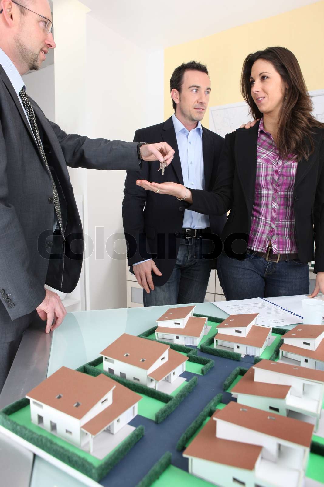 Architect handing over the keys to a new property owner | Stock image ...