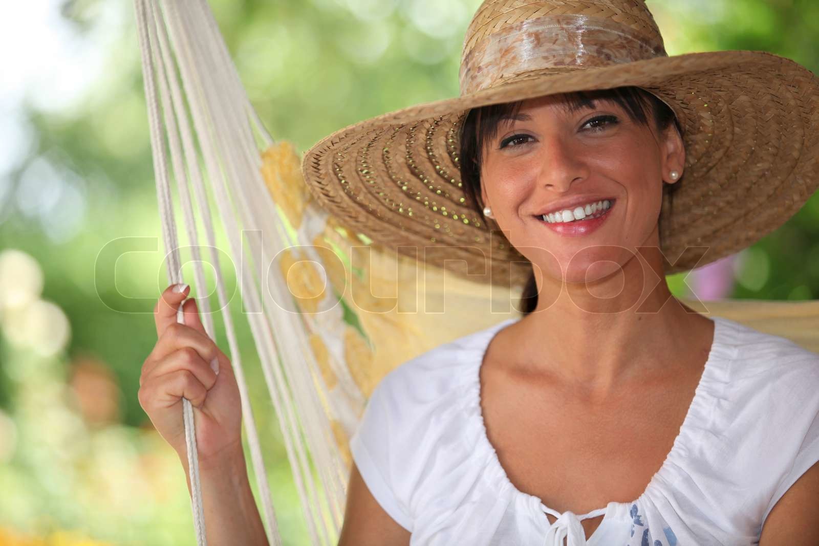 Woman wearing a straw hat | Stock image | Colourbox