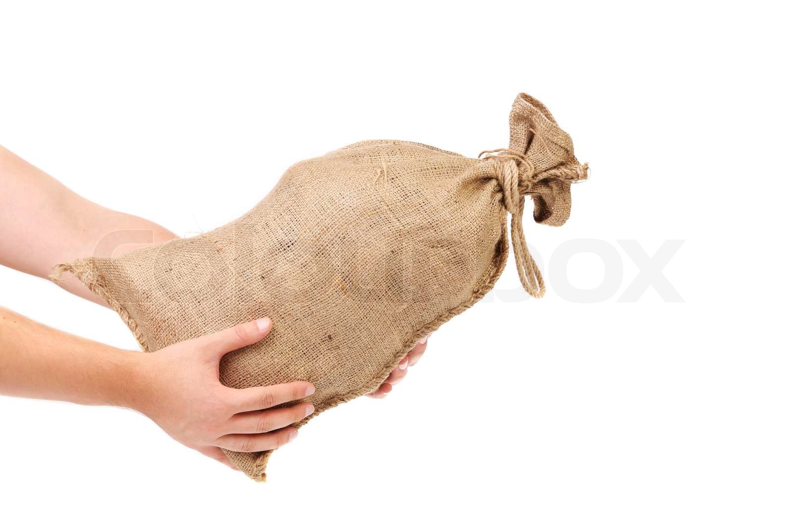 Man hand holds full tied up sack | Stock image | Colourbox