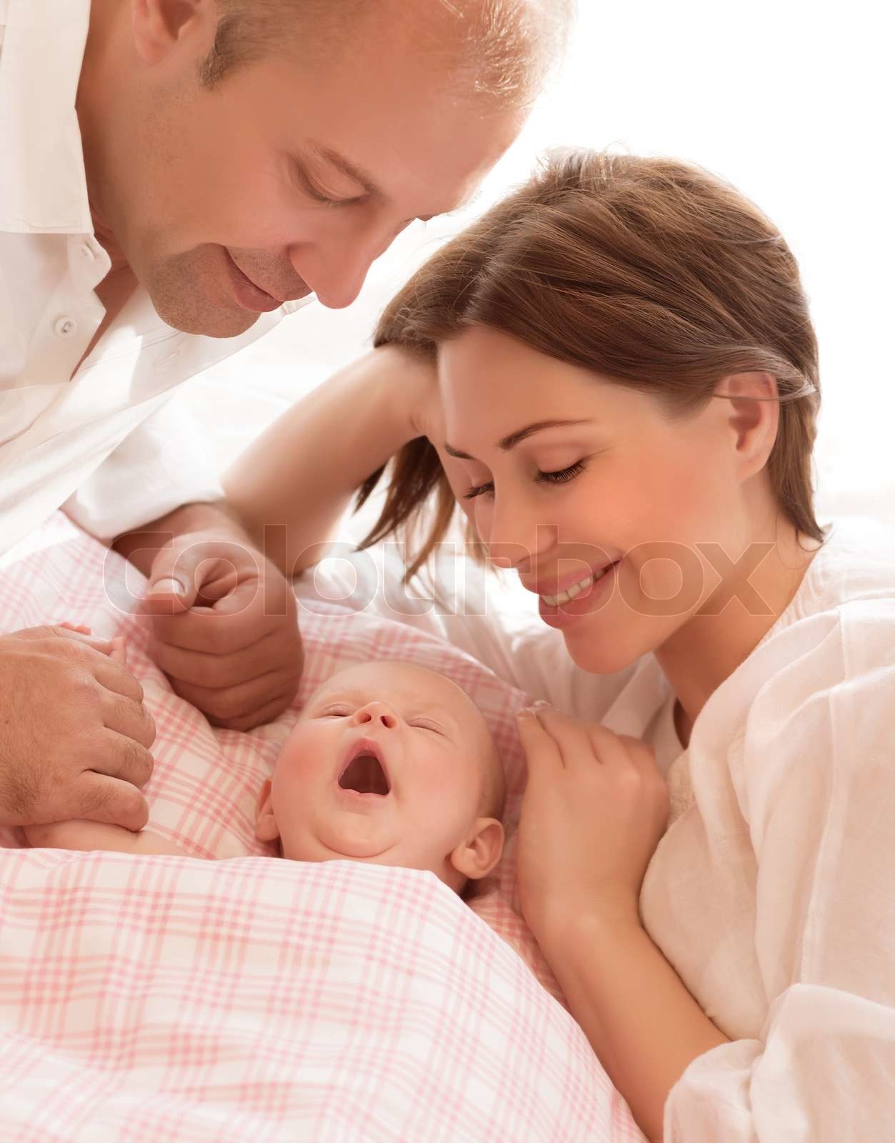 Newborn baby with parents | Stock image | Colourbox