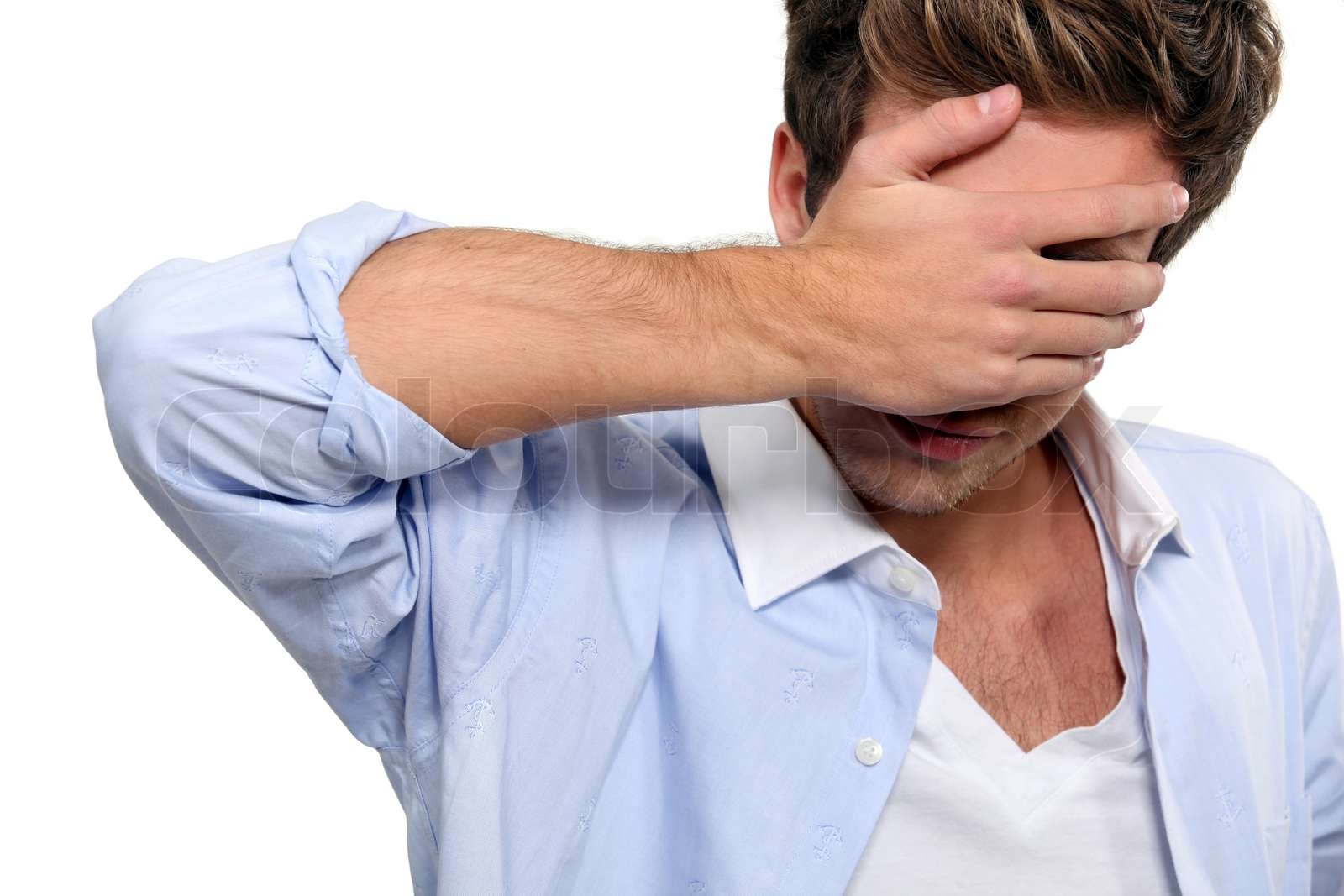 man putting his hand on his face | Stock image | Colourbox