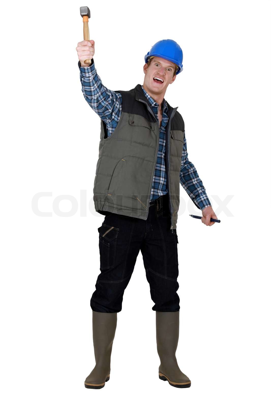 A mad construction worker with a hammer | Stock image | Colourbox