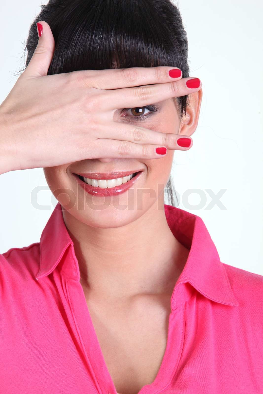 Woman covering her face with her hand | Stock image | Colourbox