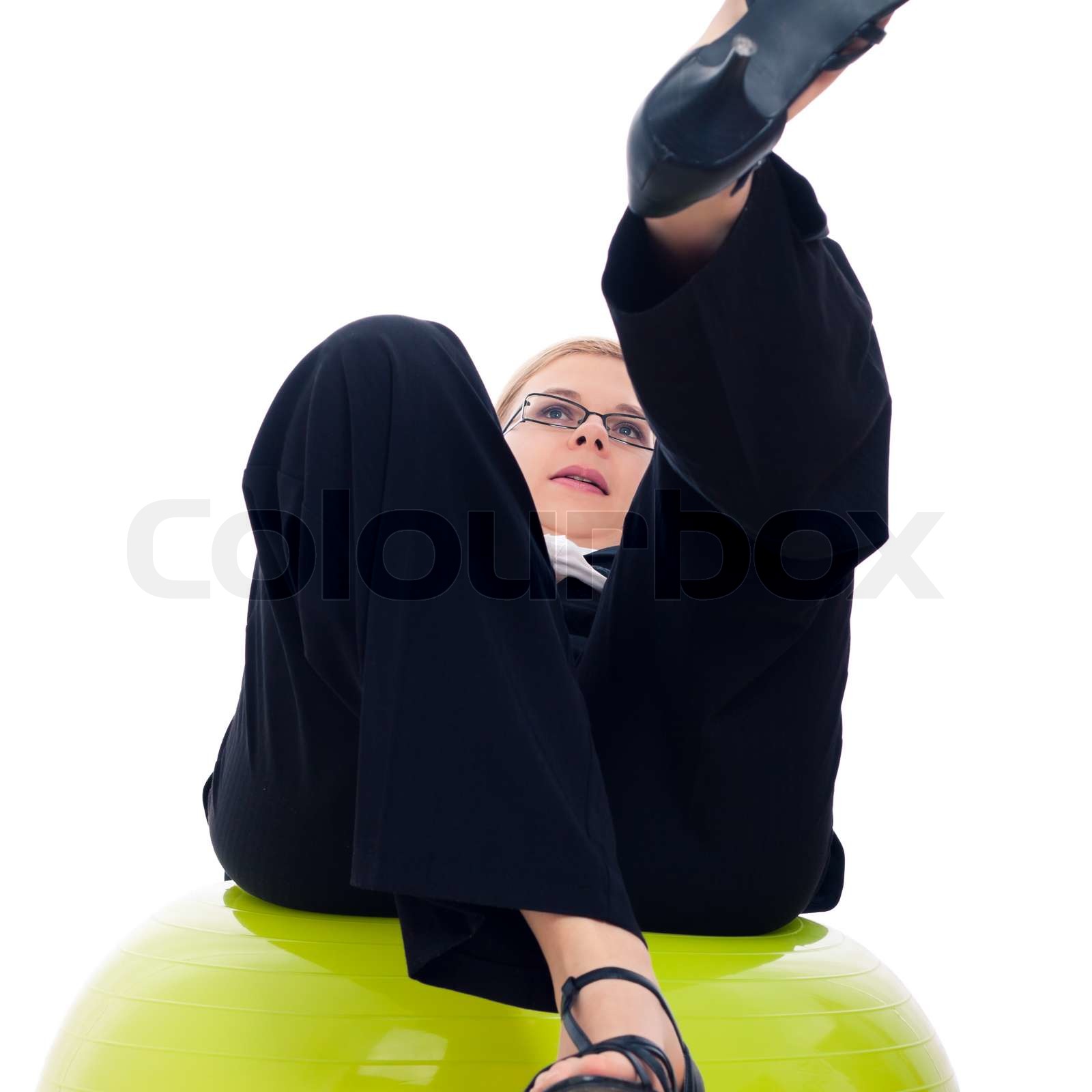 Businesswoman falling down from exercise ball | Stock image | Colourbox