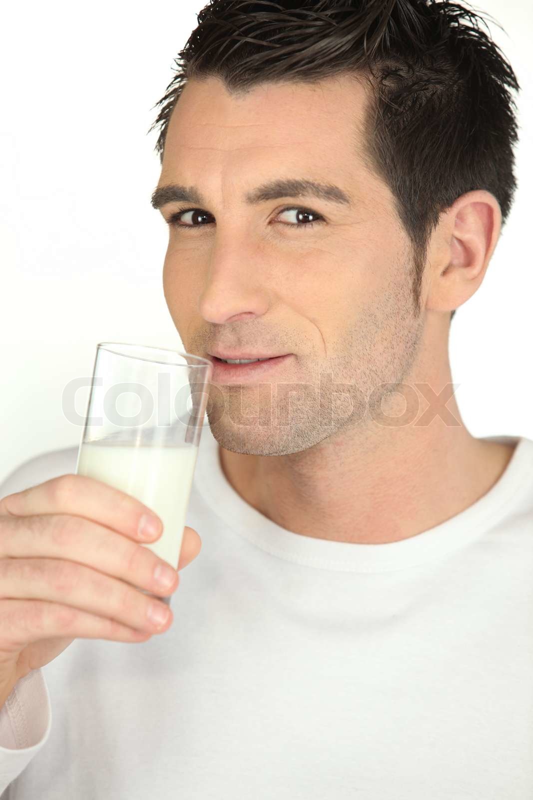 Young man with a glass of milk | Stock image | Colourbox